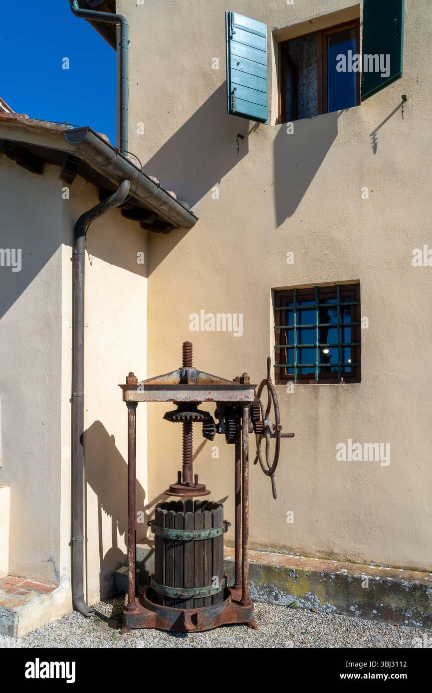 Antique rusty wine press outside a rustic building in Italy Stock Photo ...