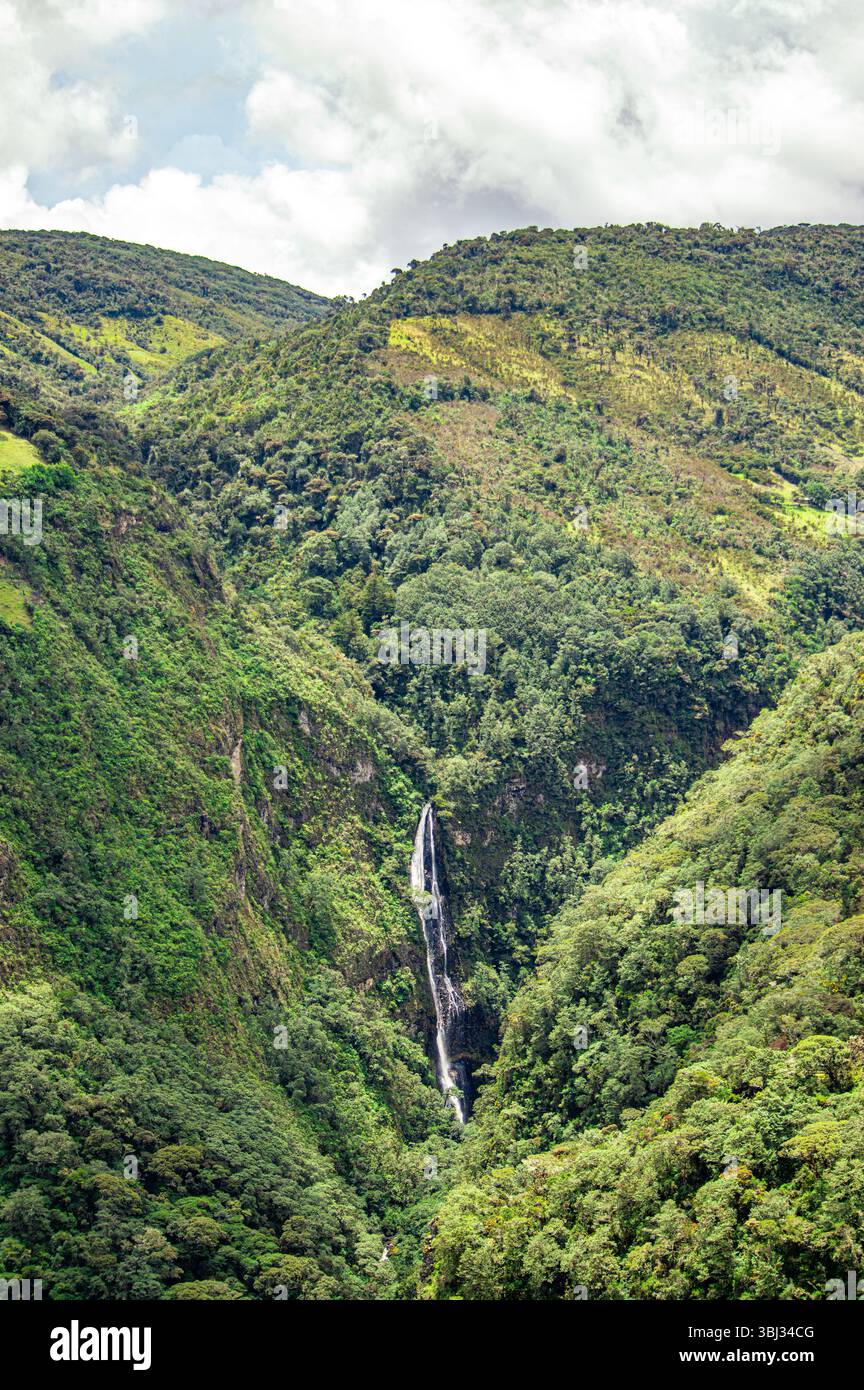 Breathtaking view of cascading waterfall amidst lush green mountains in ...