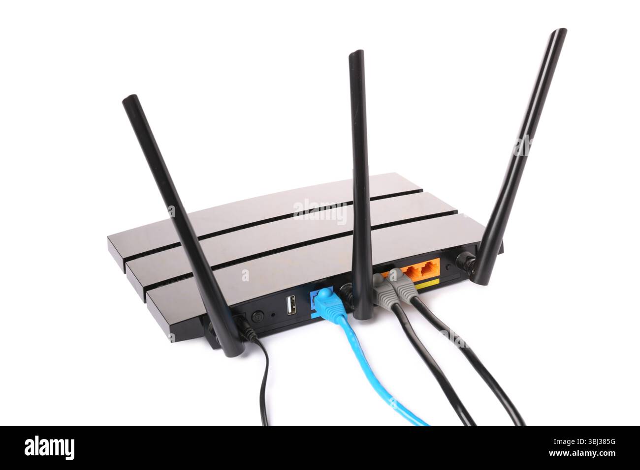 Modern wi-fi router with cables on white background Stock Photo - Alamy