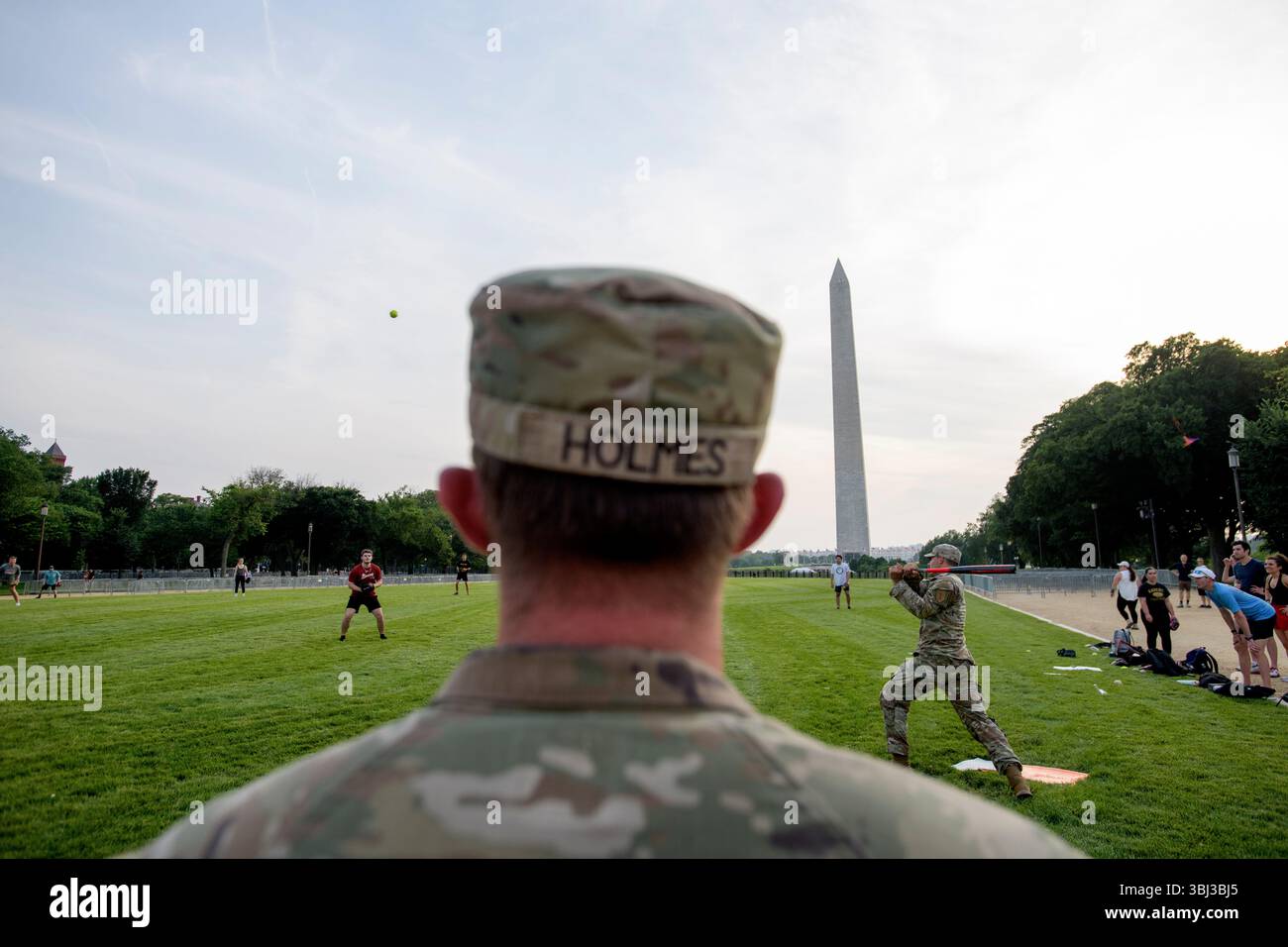 Seen through security fencing, Army Spc. Steven Holmes, left, watches ...