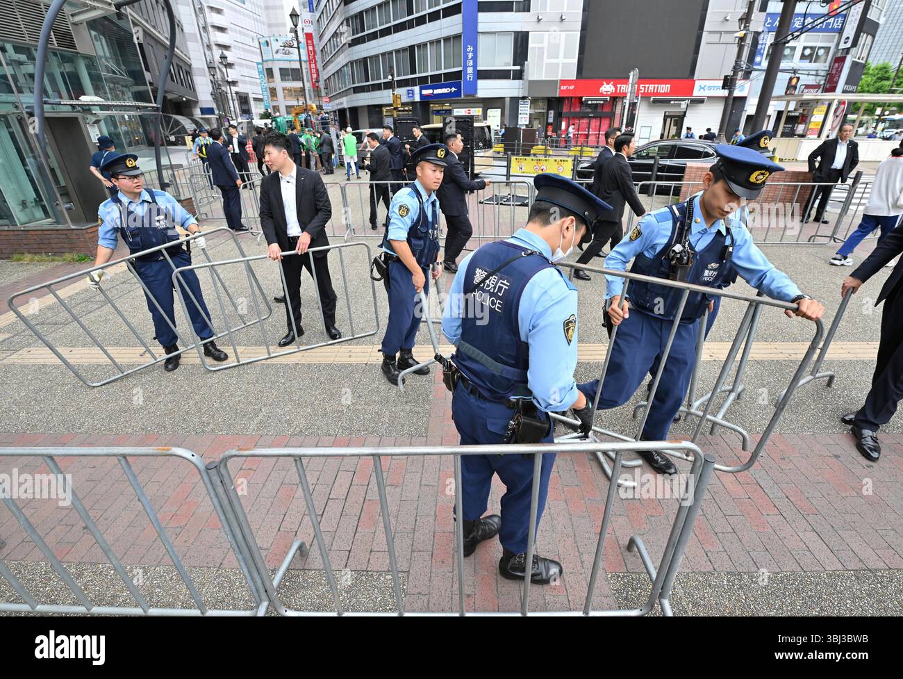 Police officers prepare for security at a campaign speech venue as the ...