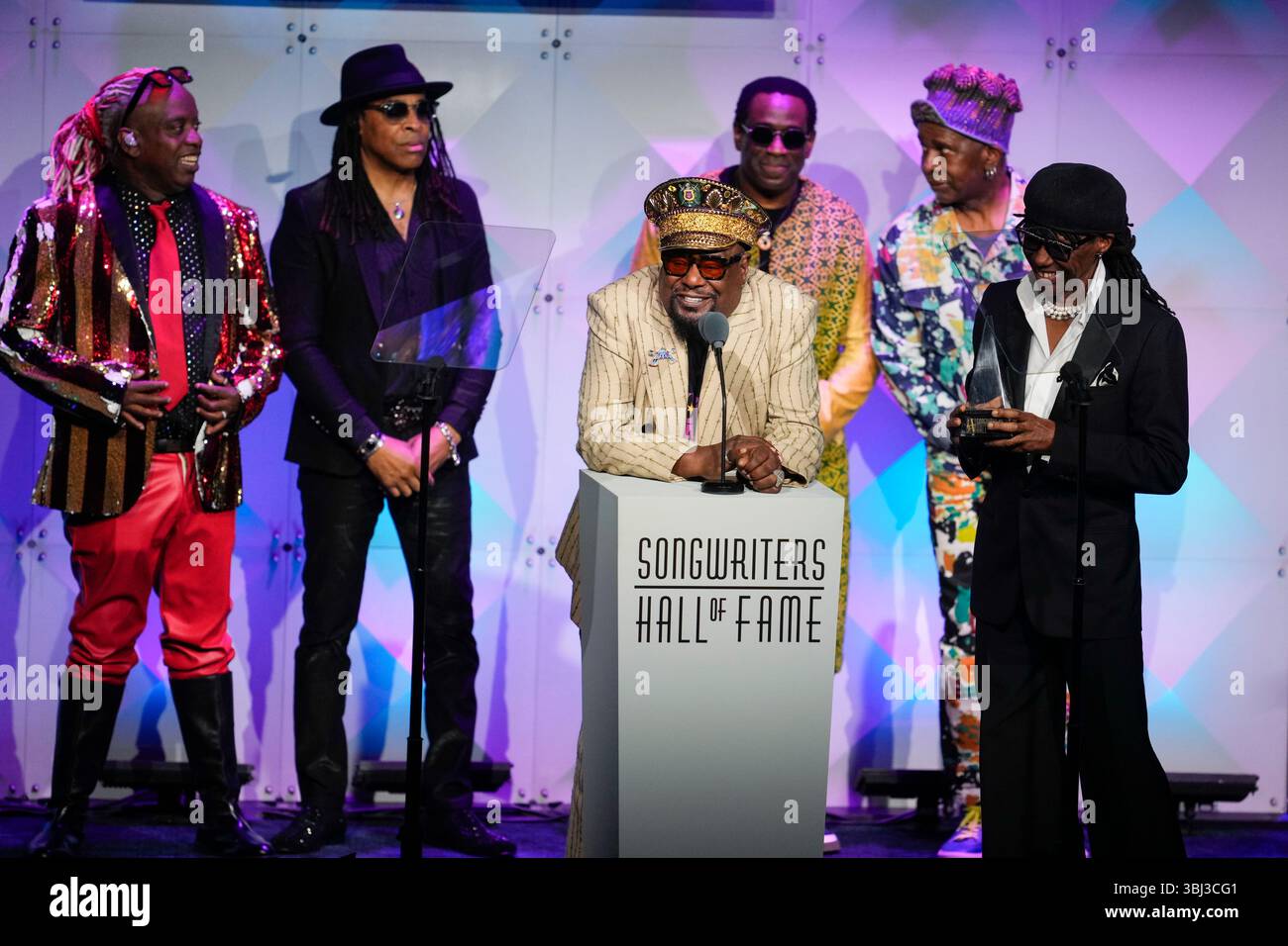 George Clinton, third from left, accepts an award from Corey Glover ...