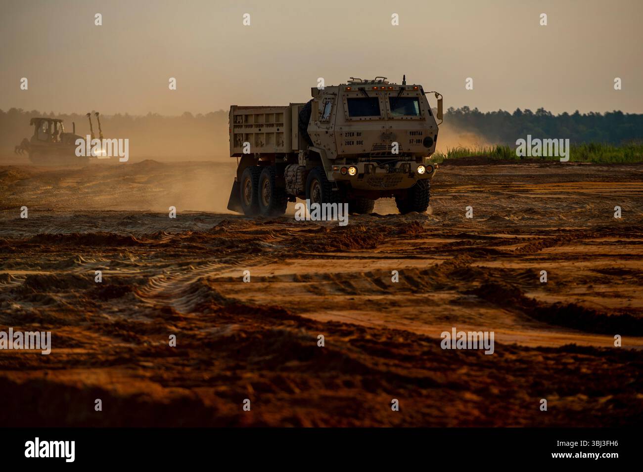 U.S. Army engineer Soldiers operate heavy machinery to construct an air ...