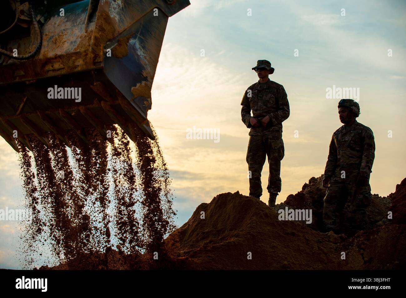 U.S. Army engineer Soldiers operate heavy machinery to construct an air ...