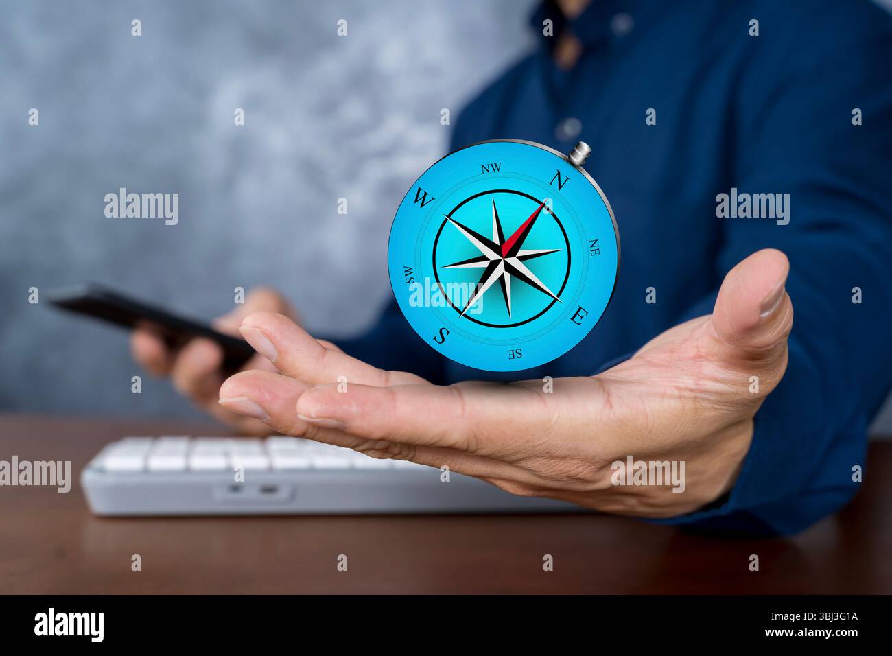A businessman holds a digital compass floating above his hand ...