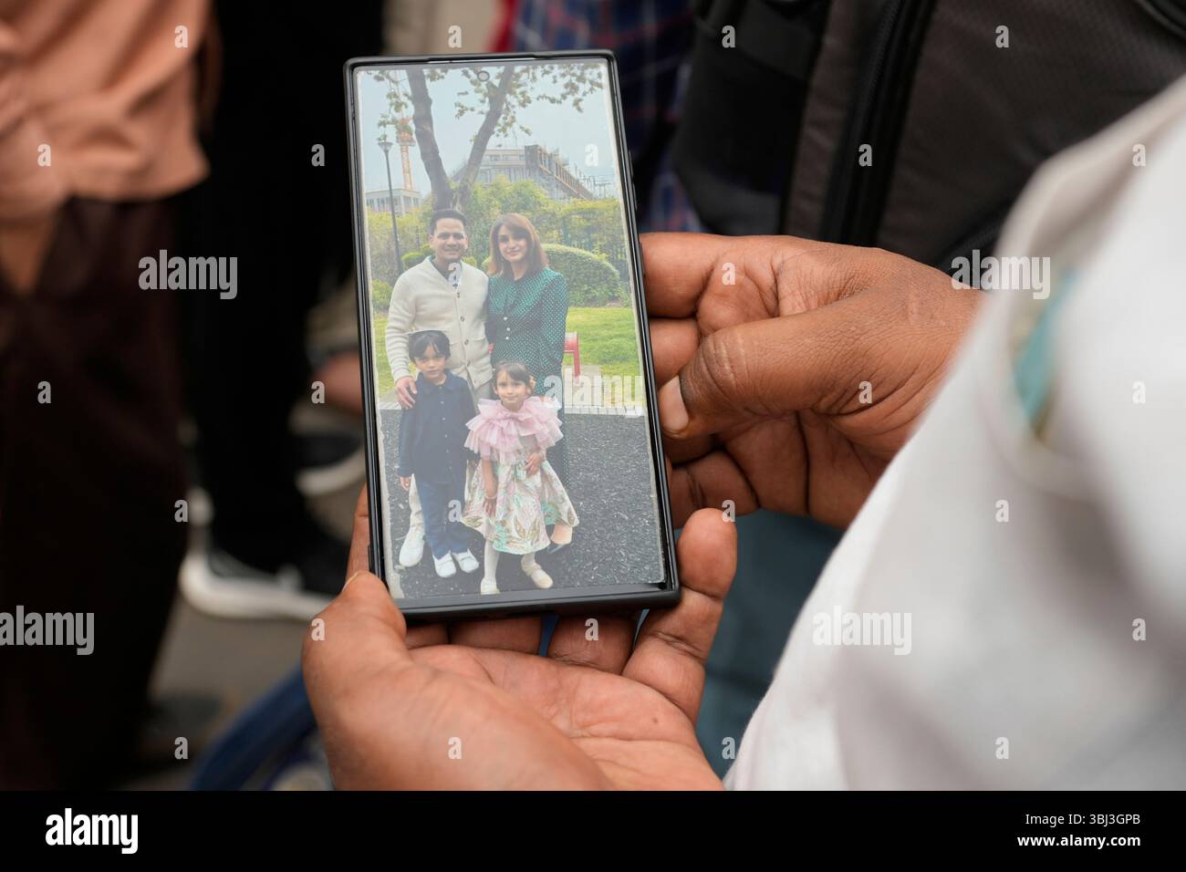 Ayub Sheikh shows a photo on his mobile phone of his nephew and the ...