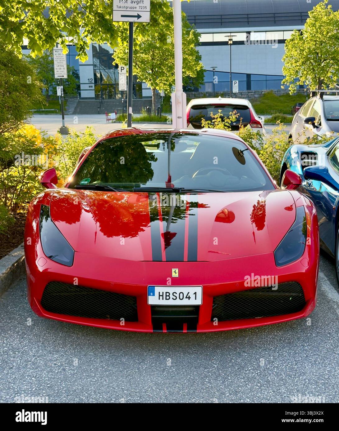 Red Ferrari parked outside Seilet Hotel in Molde, Norway Stock Photo ...
