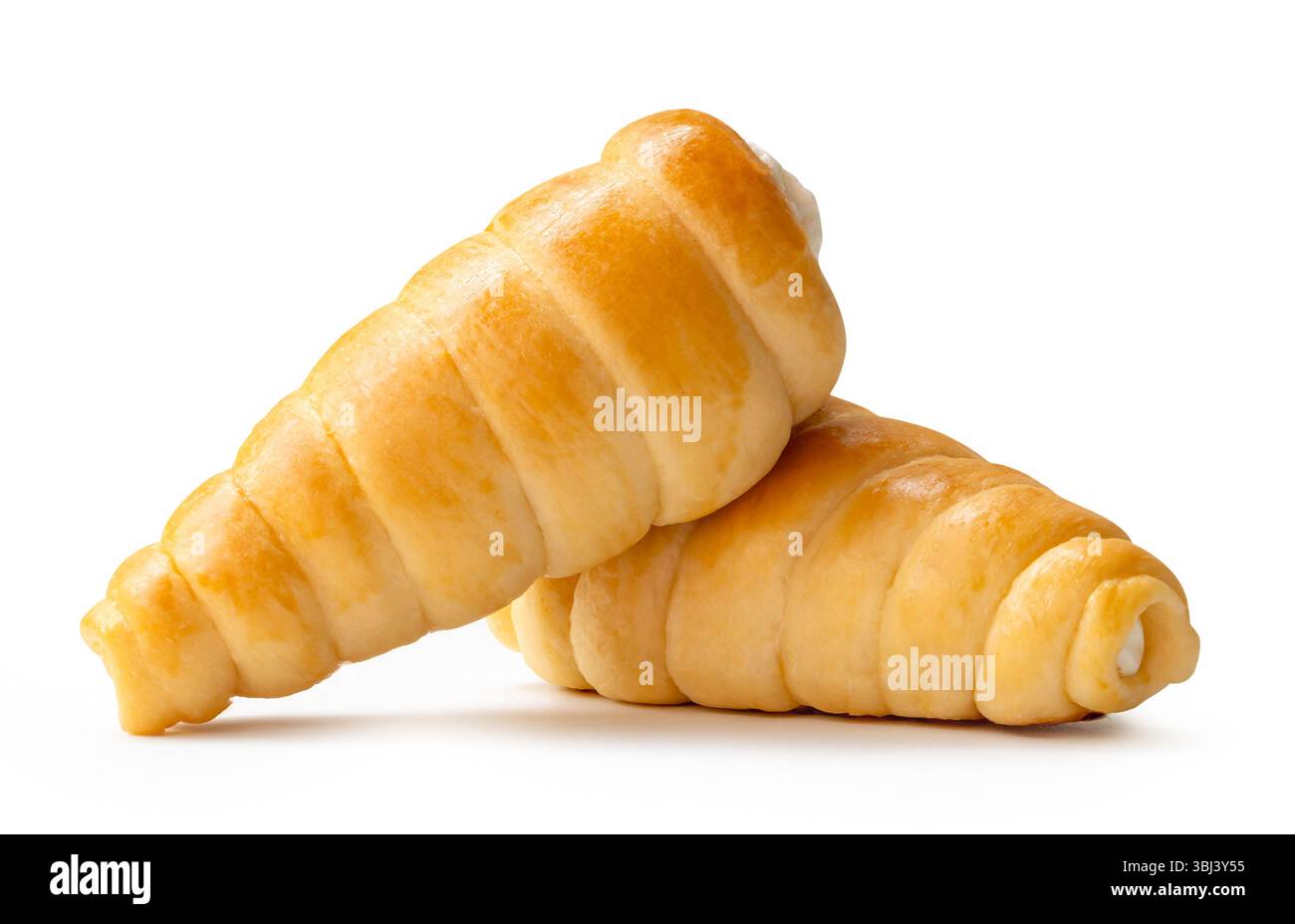 Side view of two puff pastry cream horns in stack is isolated on white ...