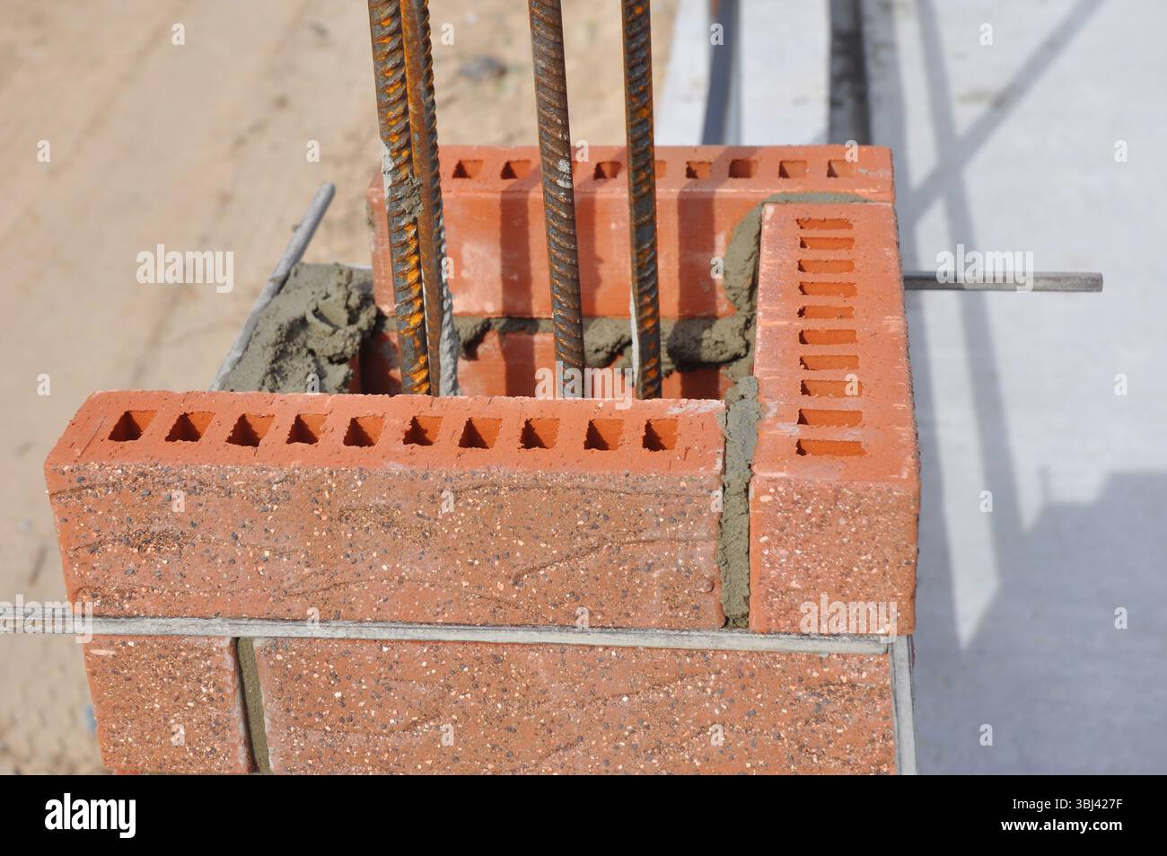 Building a brick supporting pillar with reinforcement for brick fence ...