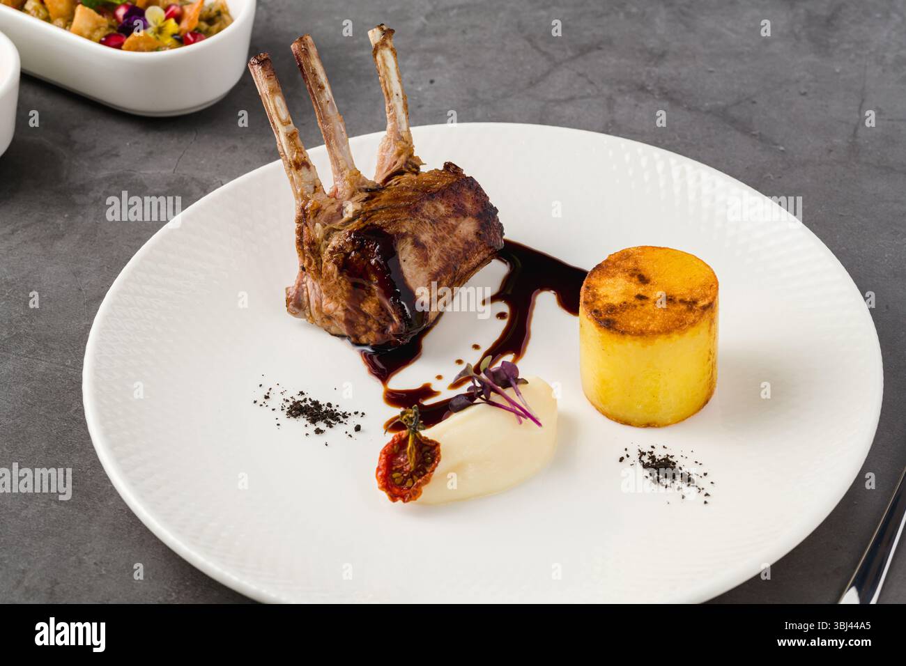 Grilled lamb chops with mashed potato, polenta cake and garnish Stock ...
