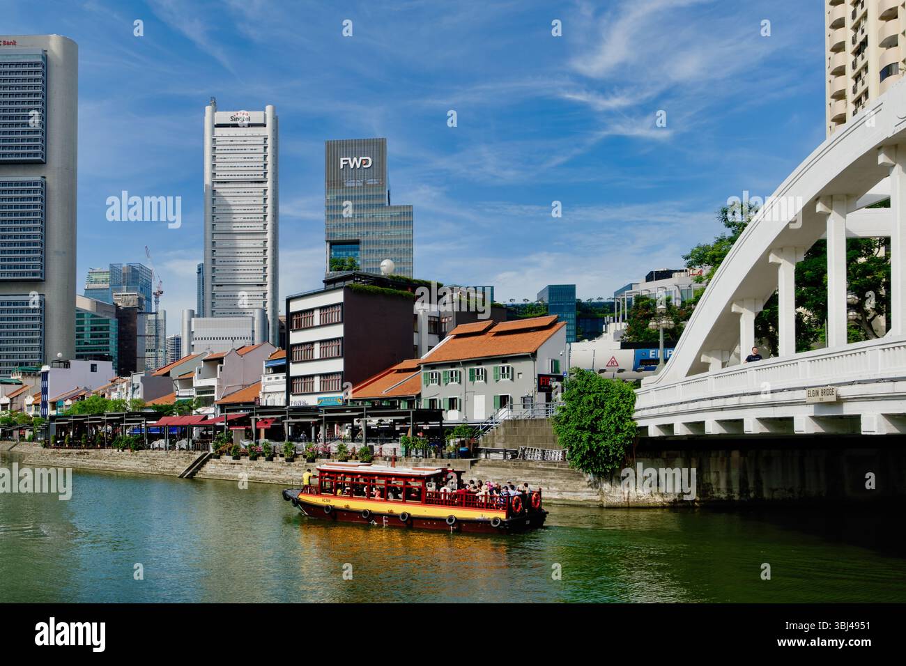 An excursion Boat on the Singapore River passes Elgin Bridge (r) and ...