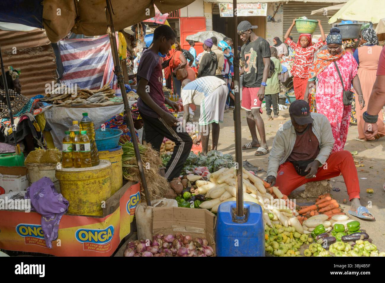 Local Senegalese people gather at the daily food market in Mbour ...
