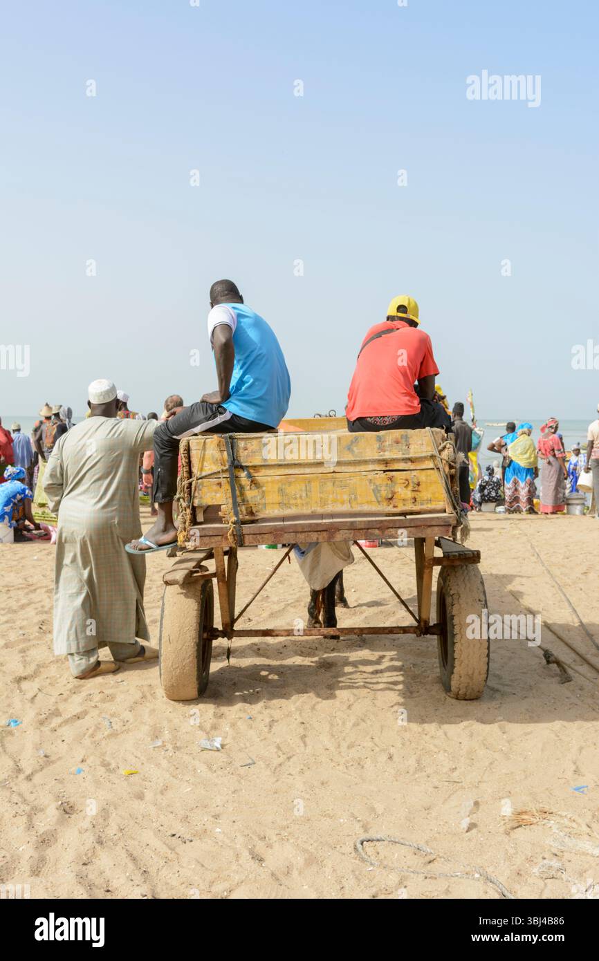 Horse drawn cart at the busy daily fish market on the beach in Mbour ...