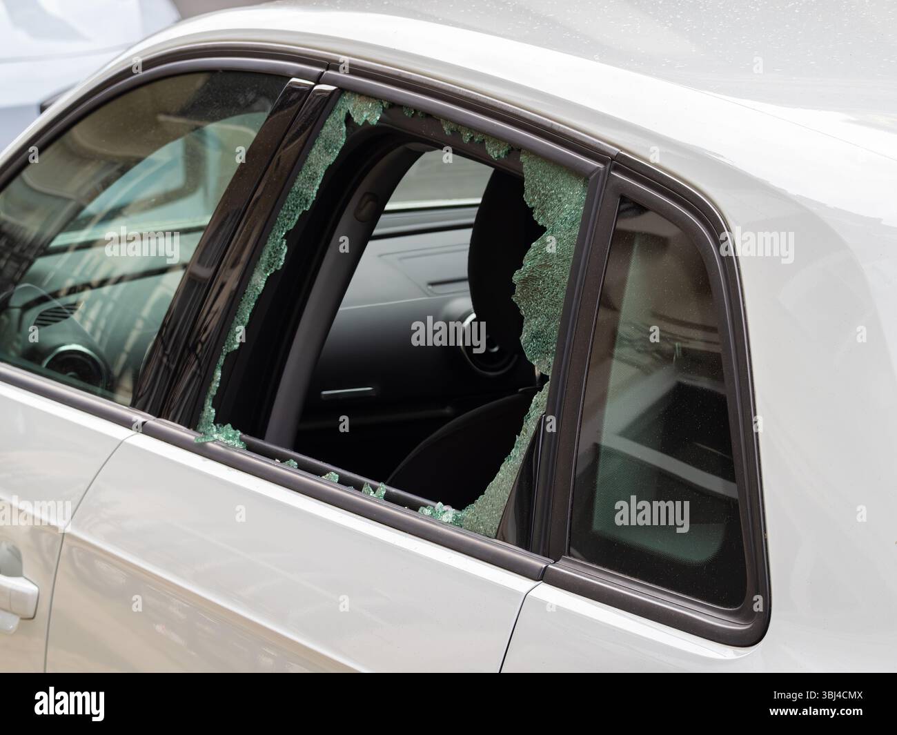 A close-up view of a car with a broken window, showcasing shattered ...