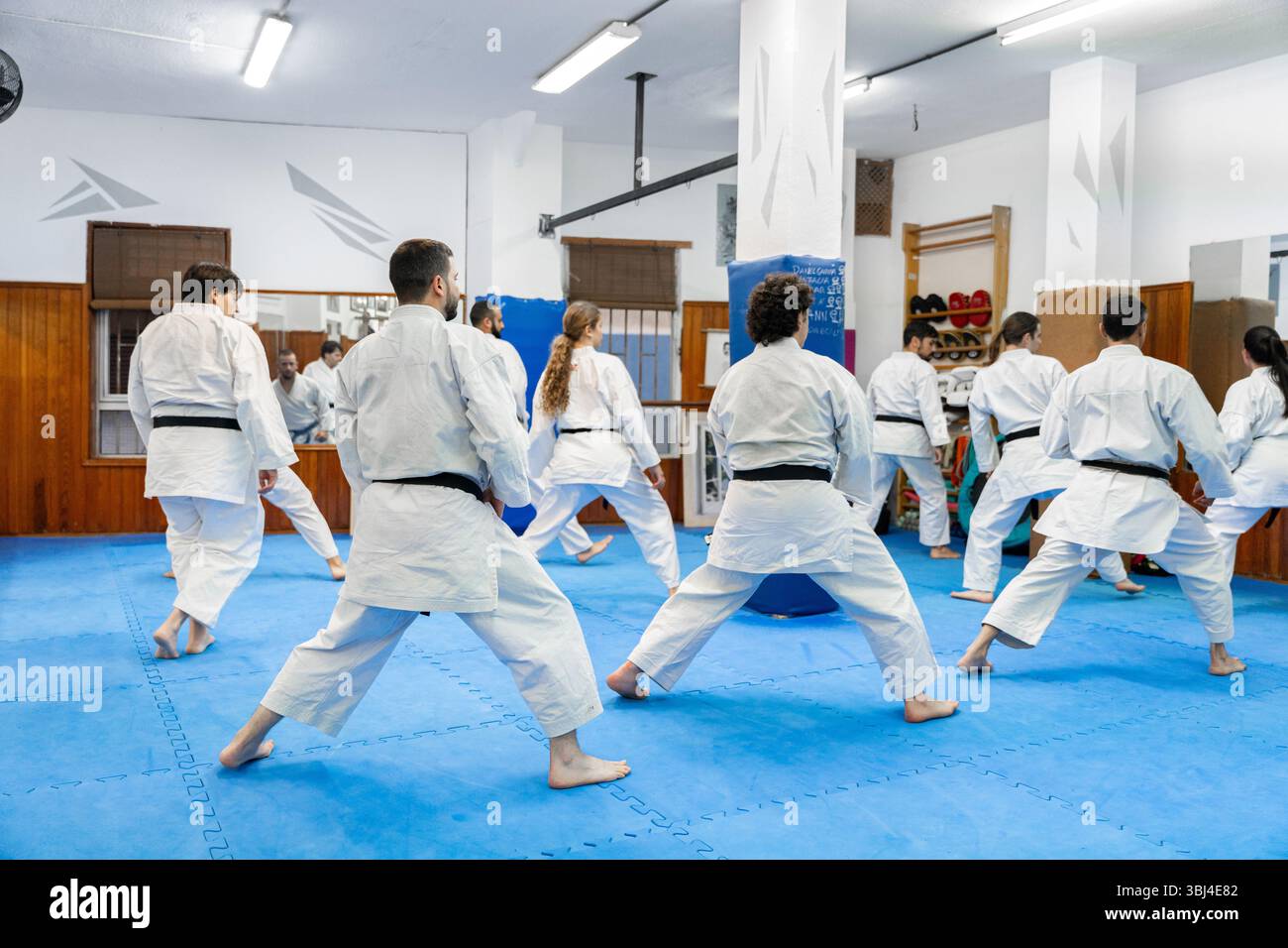 Group of karate students in white kimonos practicing martial arts ...