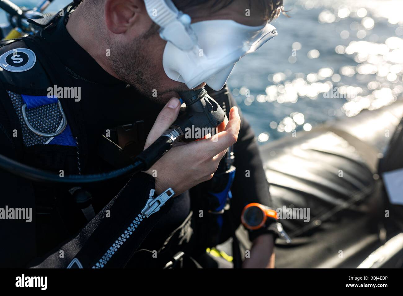 Professional diver testing his scuba diving equipment on inflatable ...