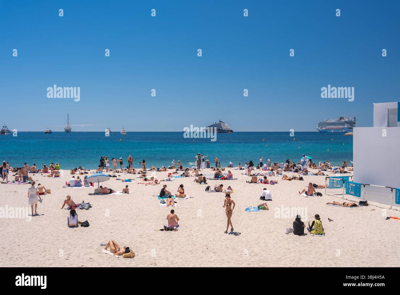 Vibrant Beach Scene with Yachts and Modern Structure in Cannes, France ...