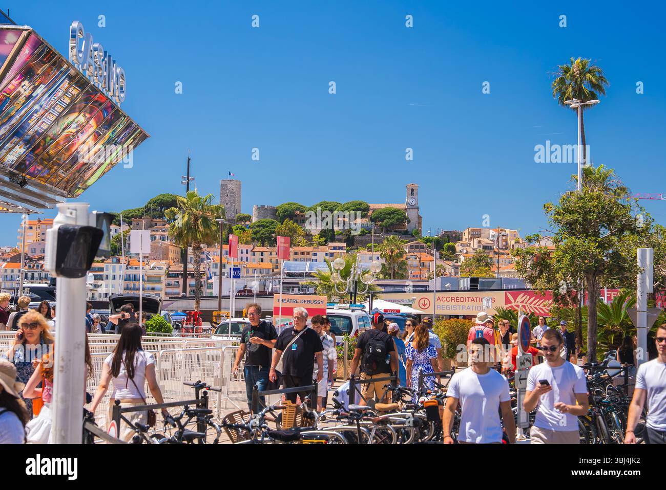 Bustling Scene in Cannes with Le Suquet and Church Clock Tower Stock ...