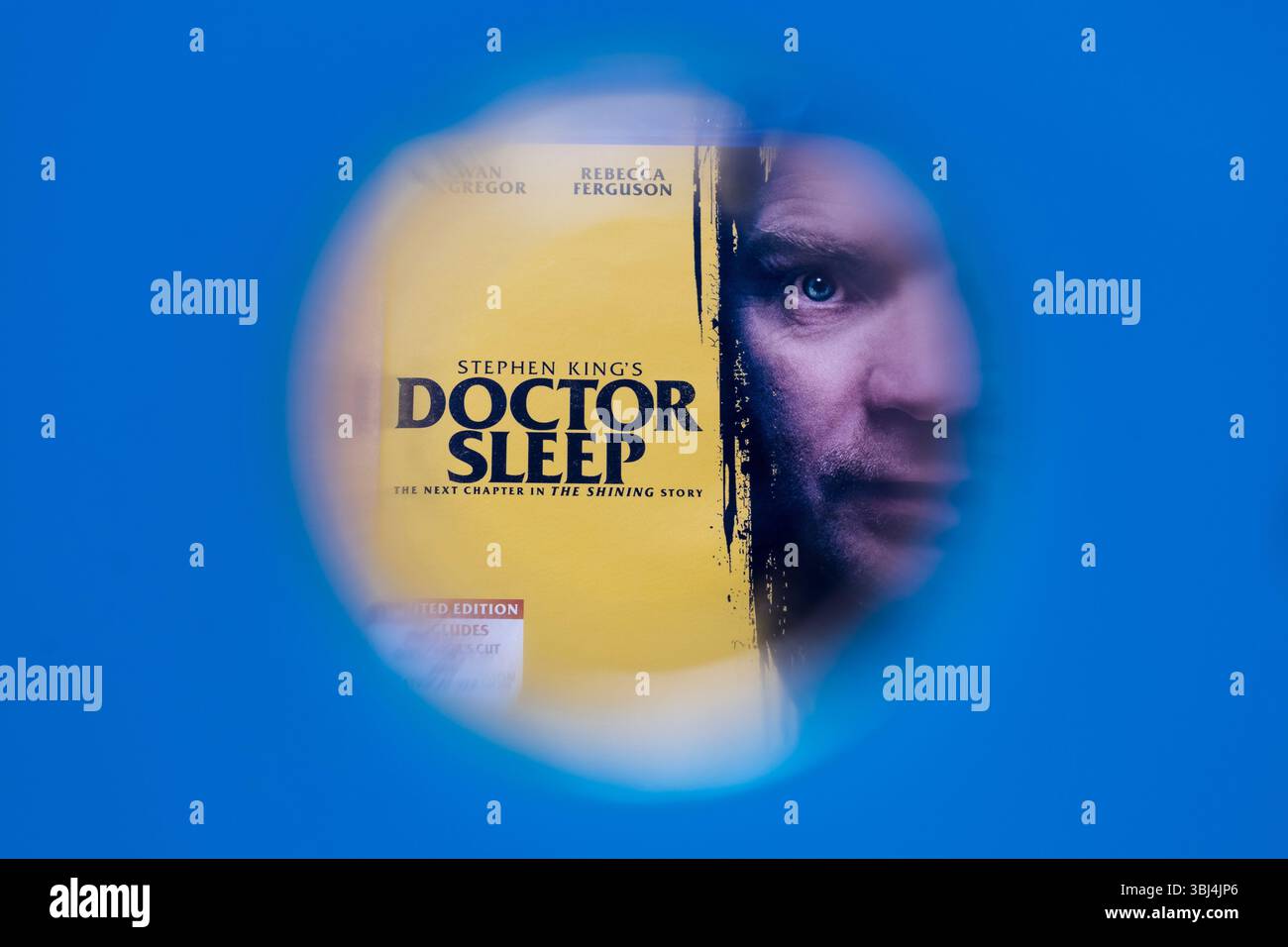 Doctor Sleep film cover seen through hole of blu-ray disc. Editorial ...