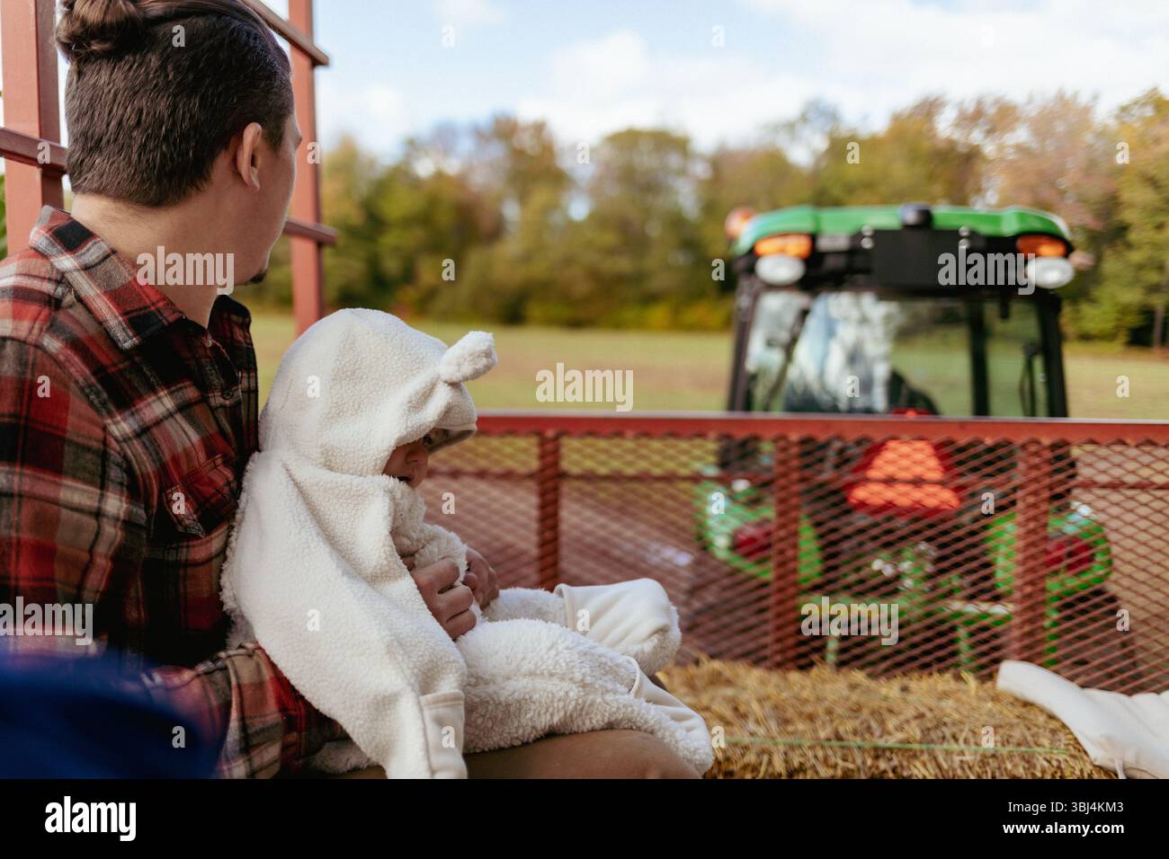 Father and baby on hay ride at corn maze Stock Photo - Alamy