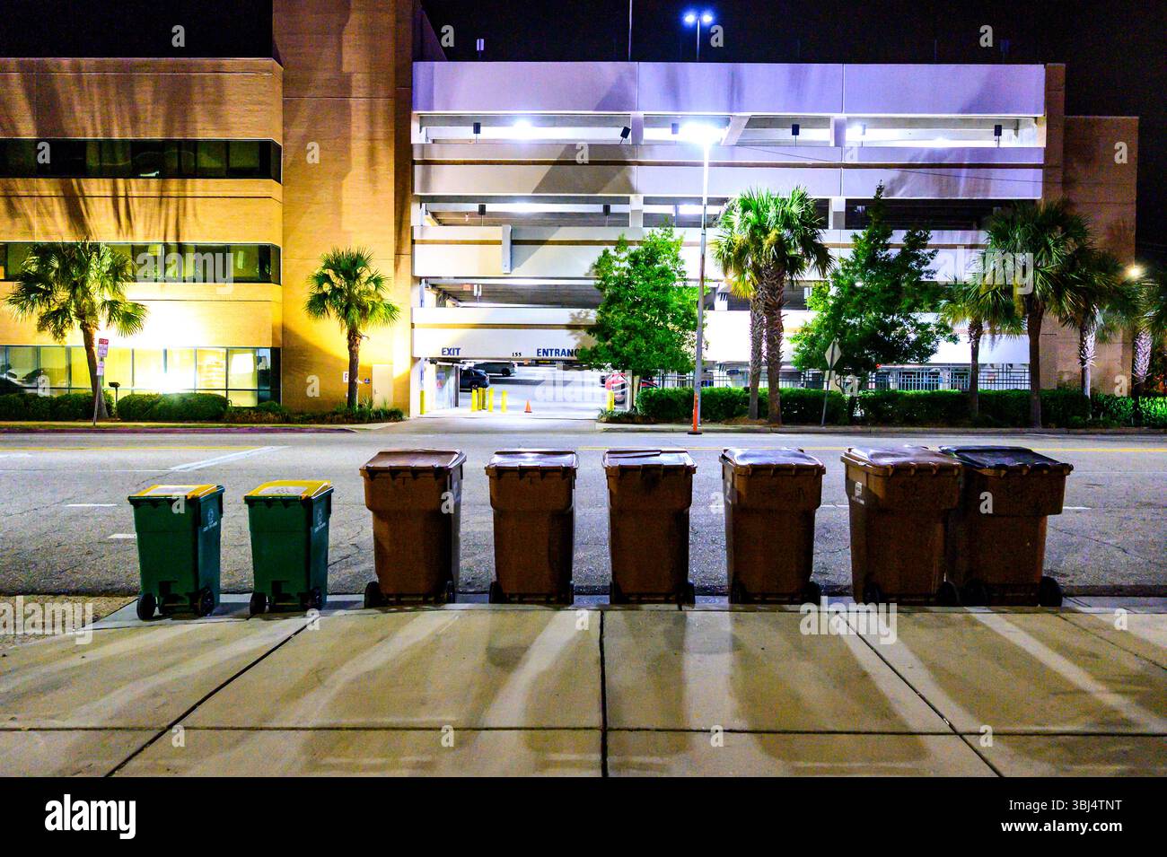 Trash cans in line on an city street Stock Photo - Alamy