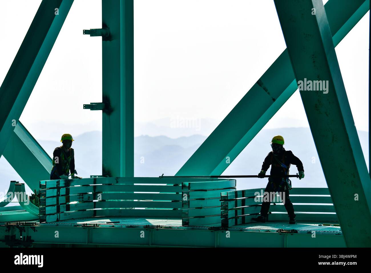 (250613) -- GUANLING, June 13, 2025 (Xinhua) -- Workers build a ...