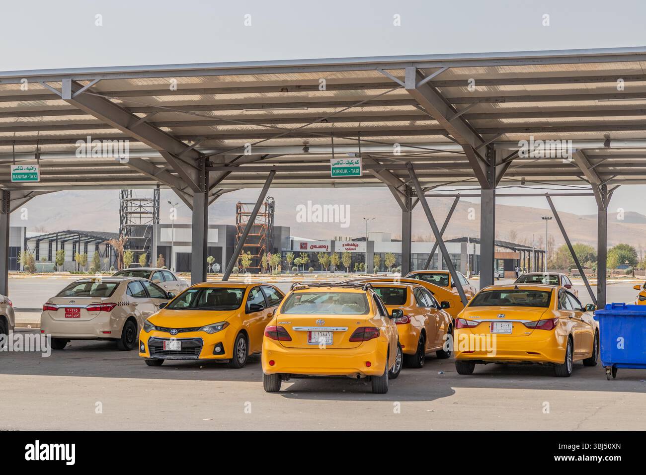 SULAYMANIYAH, IRAQ - OCTOBER 7, 2022: Intercity taxis wait at the ...