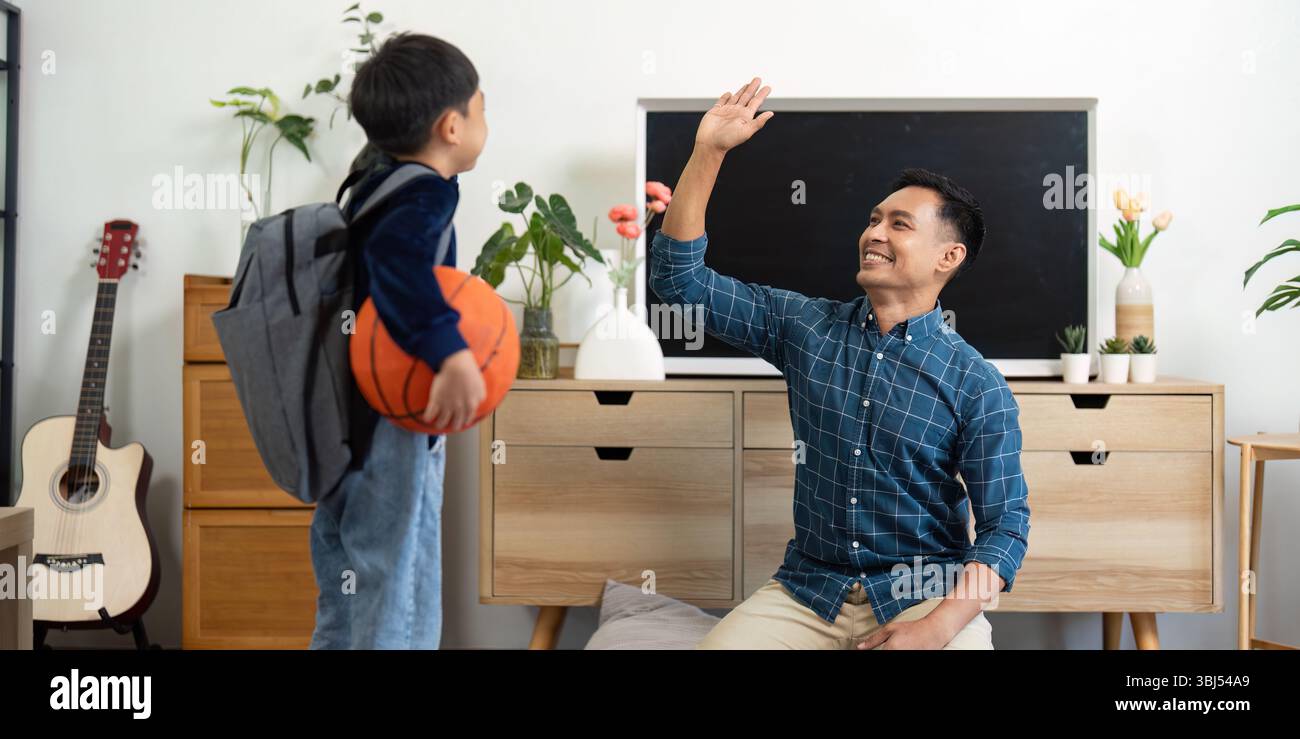 Father and Son Bonding. Joyful moment with a child waving goodbye ...