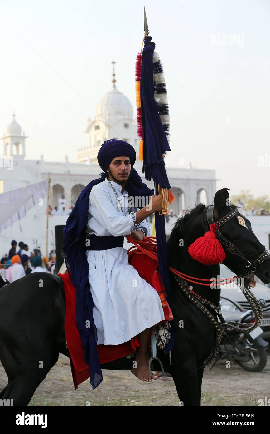 Traditional Sikh warrior order, Nihangs, in India A Nihang Sikh poses with his horse during a ...