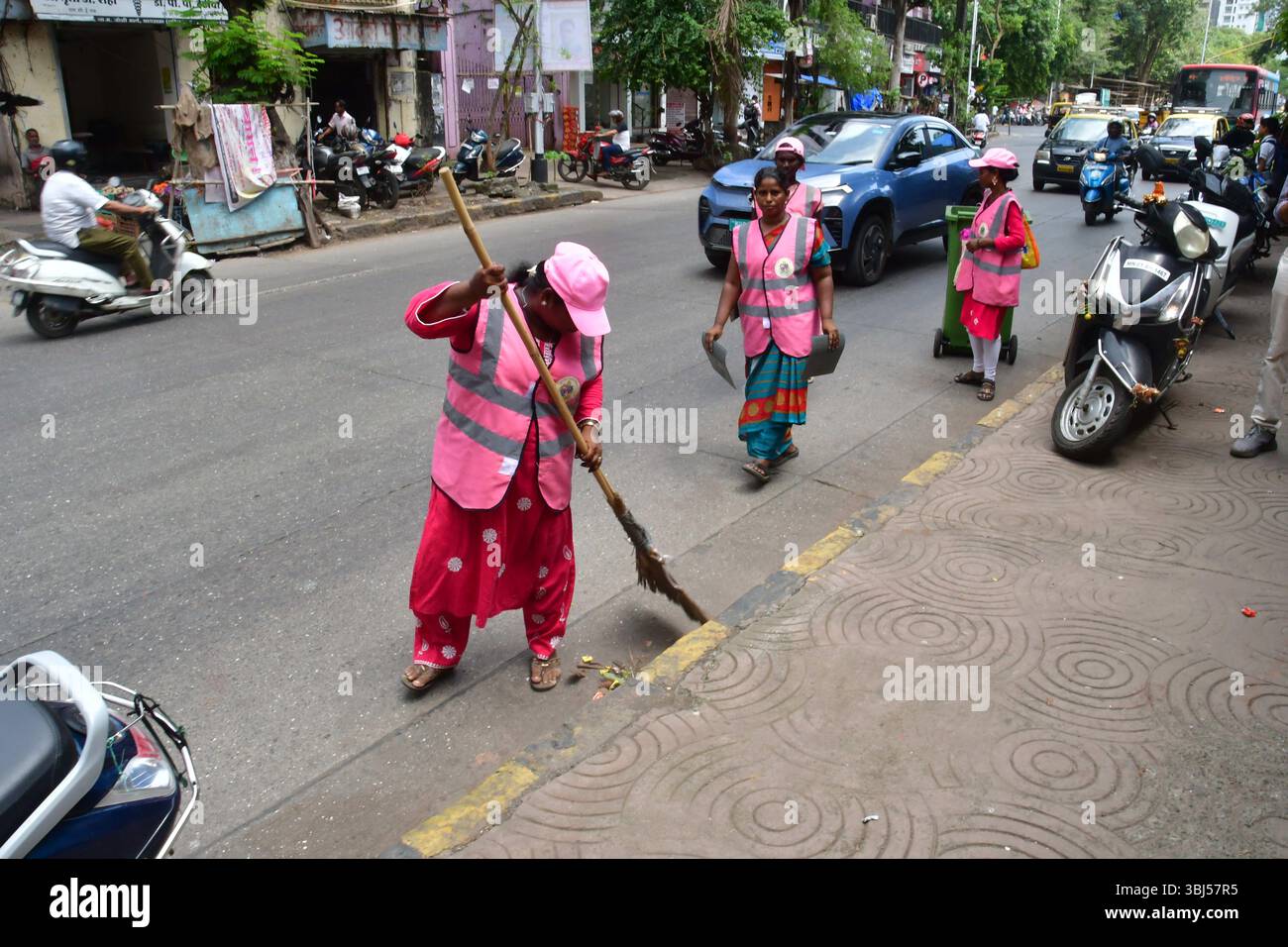 MUMBAI, INDIA - JUNE 11: BMC "Pink Army" women cleaning the streets ...