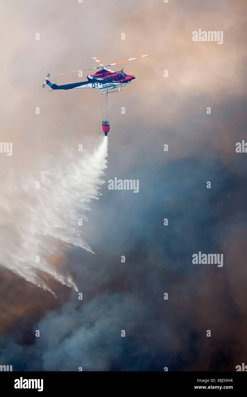 Helicopter in fire-fighting operation Stock Photo - Alamy