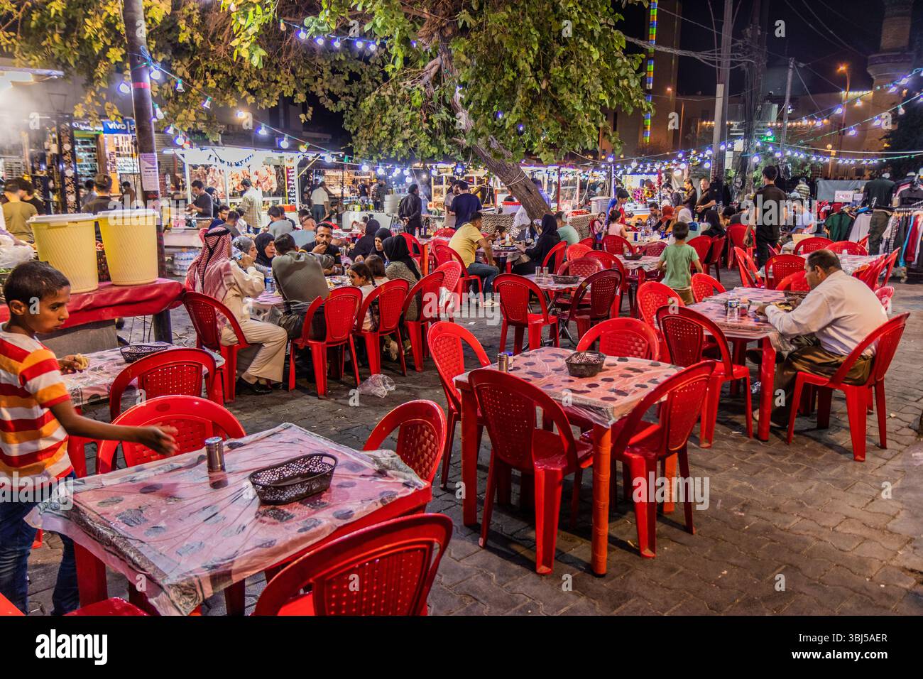 SULAYMANIYAH, IRAQ - OCTOBER 5, 2022: Street food stalls and tables in ...