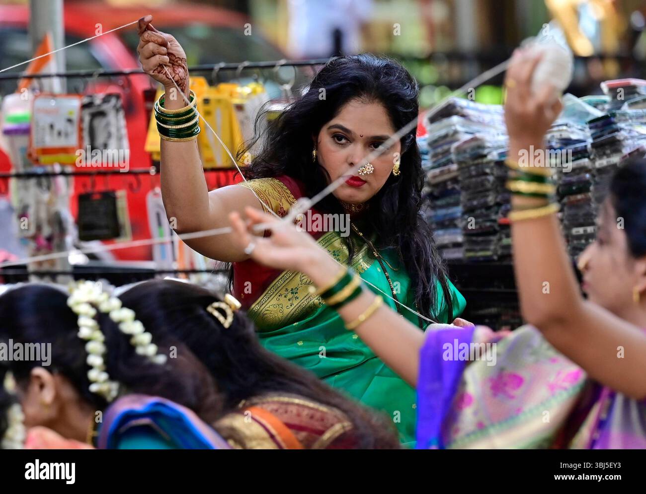 MUMBAI, INDIA - JUNE 10: Women's tying threads and performing puja ...