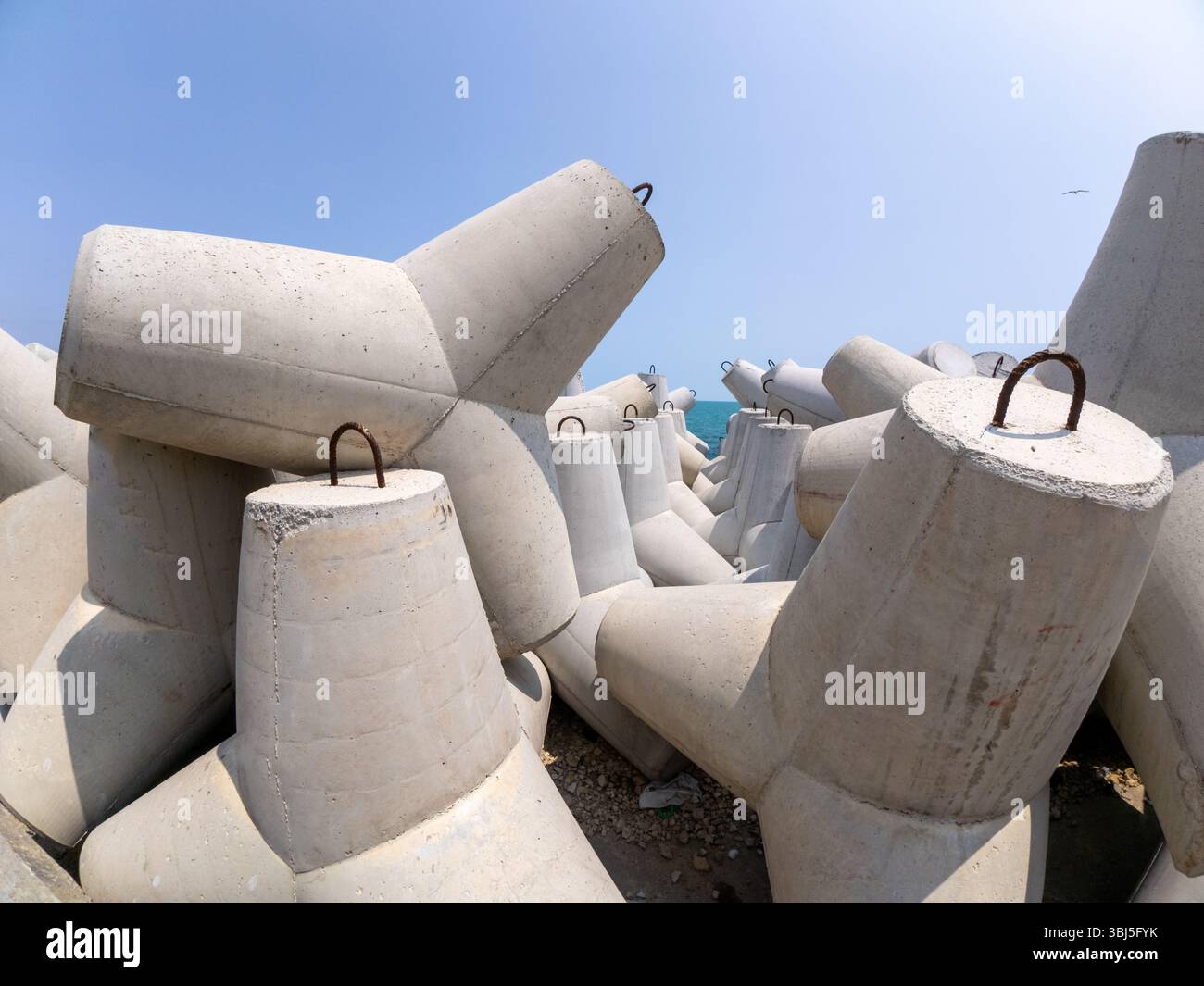 Close-up large concrete tetrapods stacked on a coastal breakwater ...