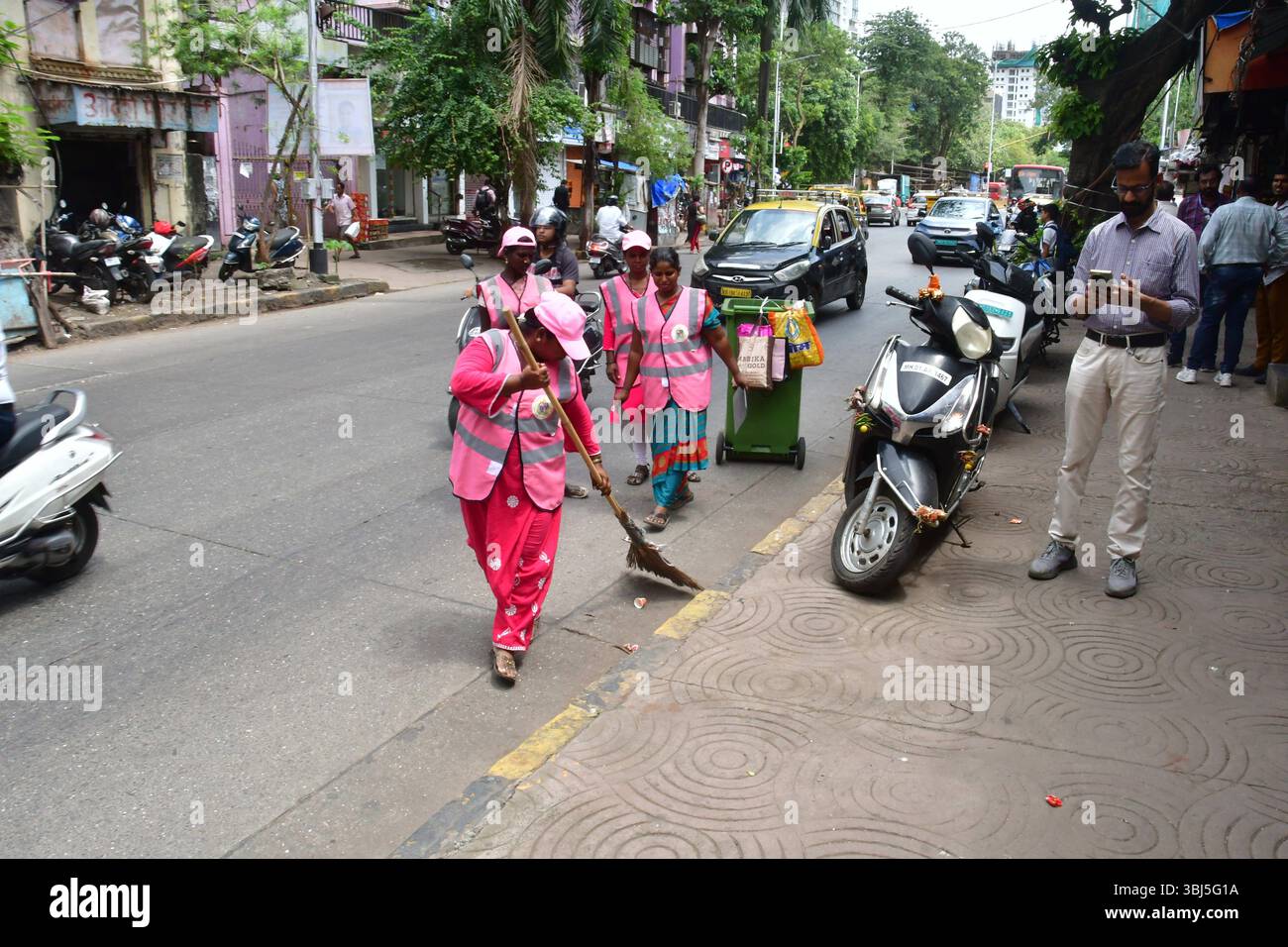 MUMBAI, INDIA - JUNE 11: BMC "Pink Army" women cleaning the streets ...