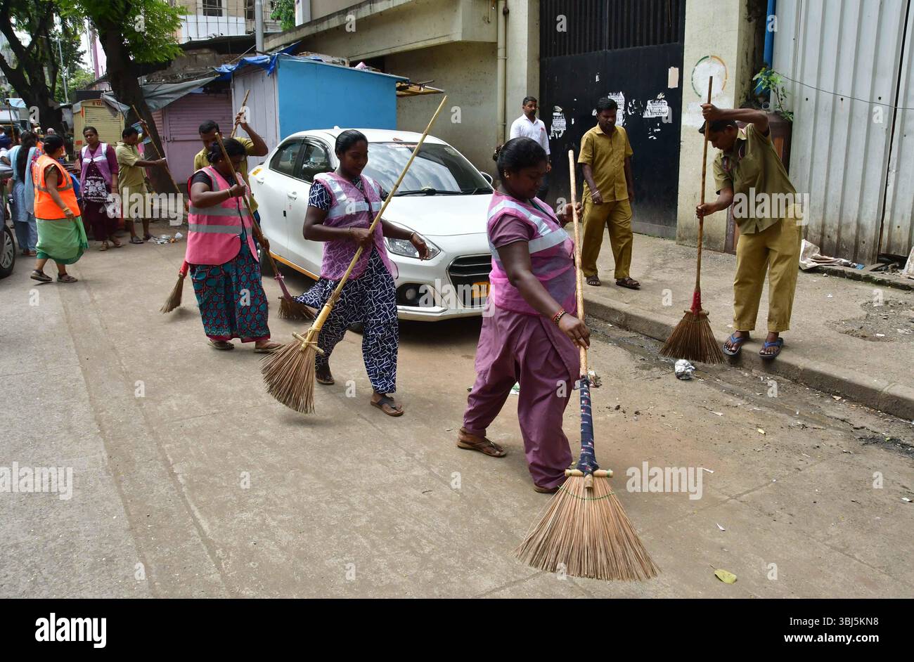 MUMBAI, INDIA - JUNE 11: BMC "Pink Army" women cleaning the streets ...