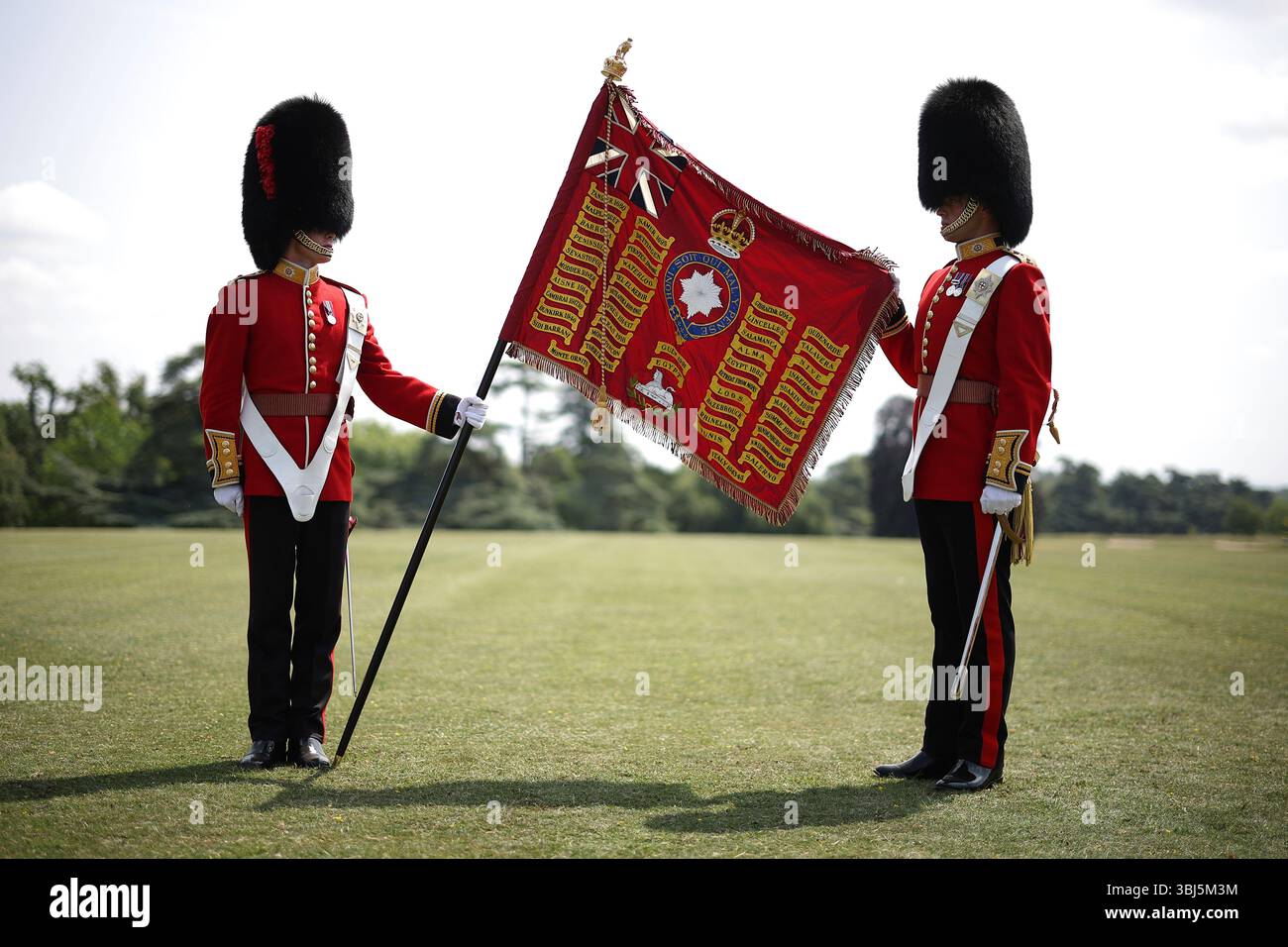 Soldiers of the 1st and 2nd Battalion (Number 7 Company) the Coldstream Guards display the King ...
