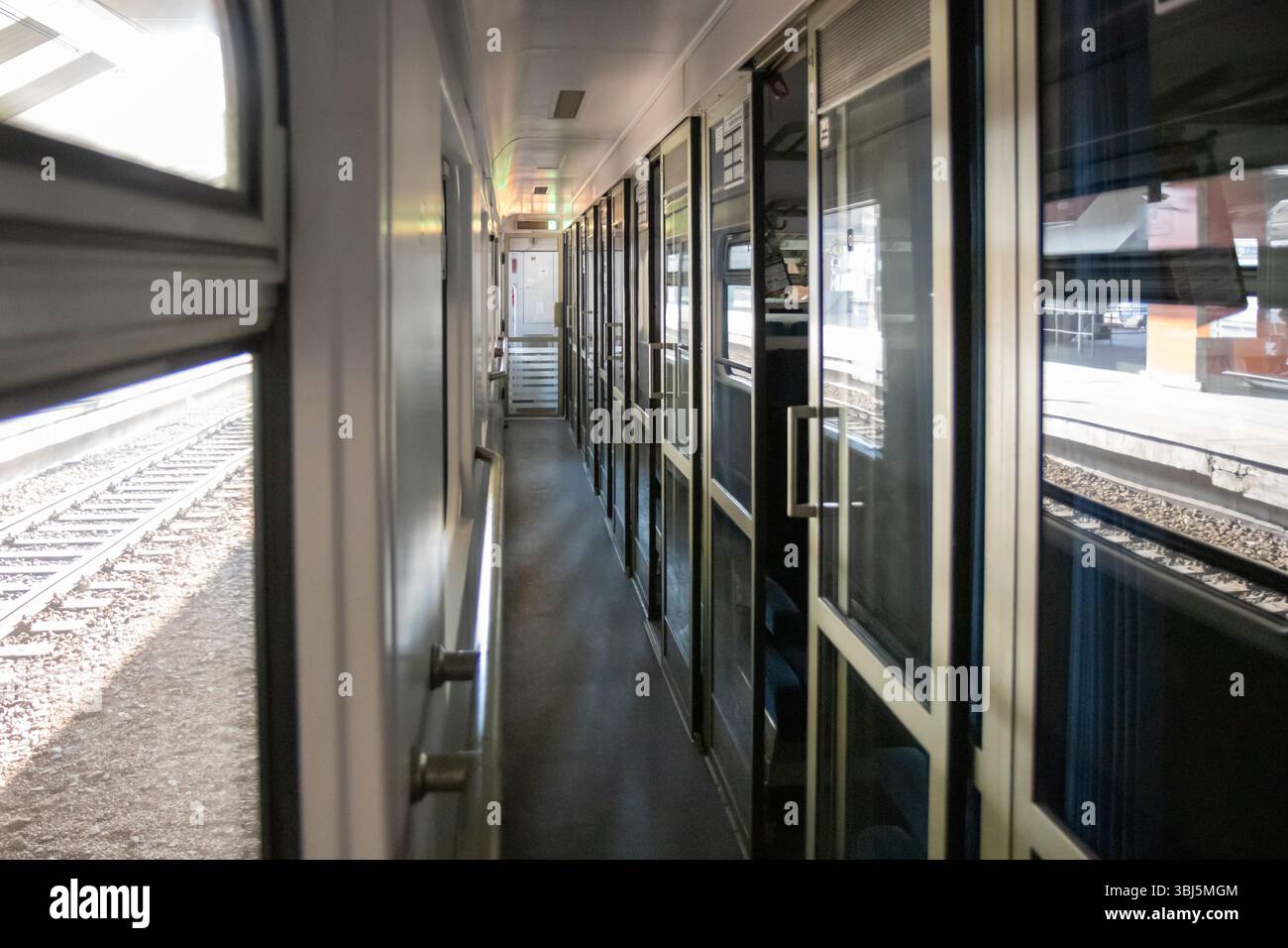 A corridor inside a passenger Second-class train carriage in Poland ...