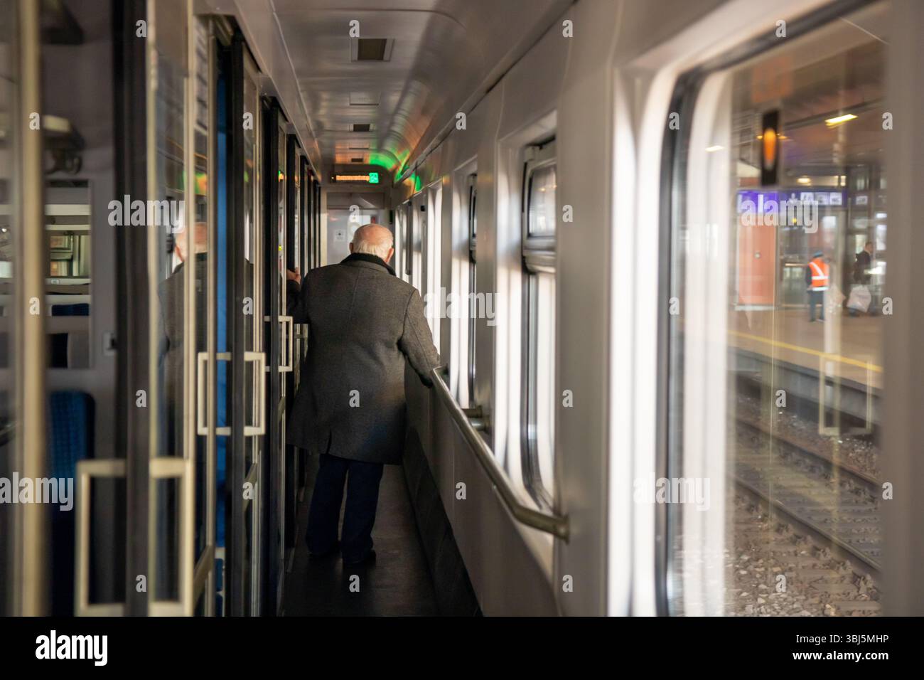 A corridor inside a passenger Second-class train carriage in Poland ...