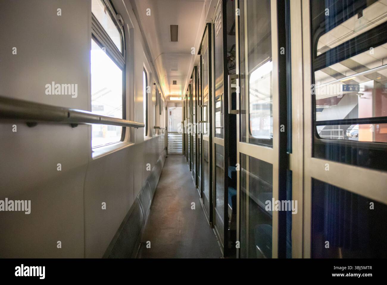 A corridor inside a passenger Second-class train carriage in Poland ...