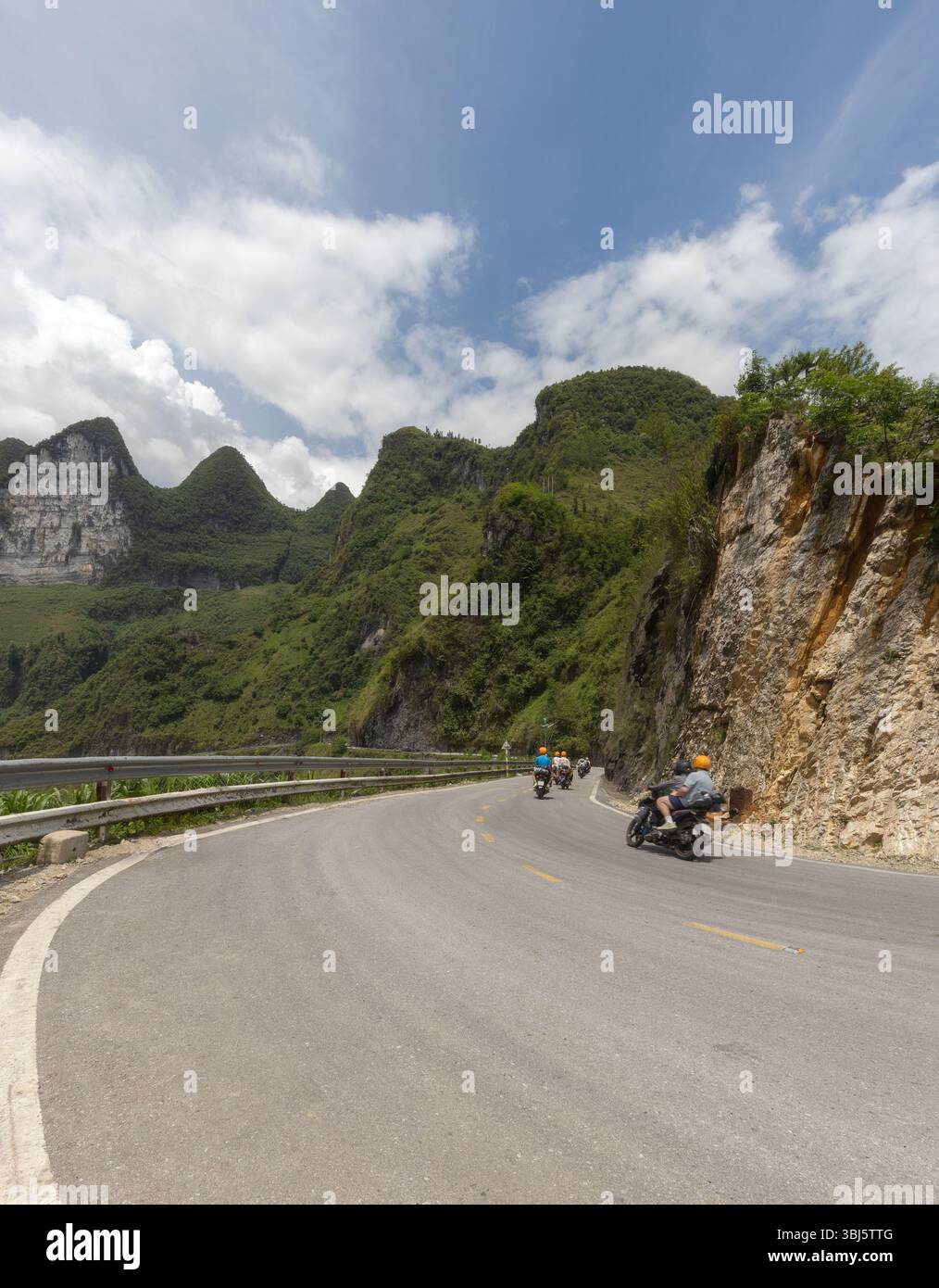 Group of bikers riding the winding road of Ma Pi Leng pass of Ha Giang ...