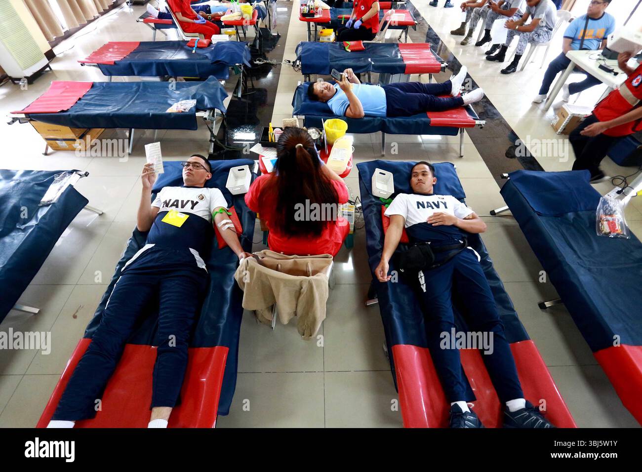 Philippines. 13th June, 2025. Members of man in uniform donating their ...