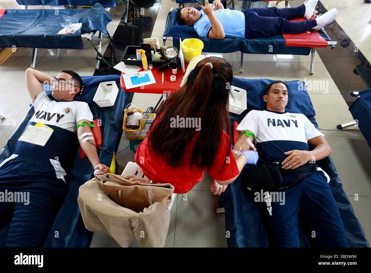 Philippines. 13th June, 2025. Members of man in uniform donating their ...