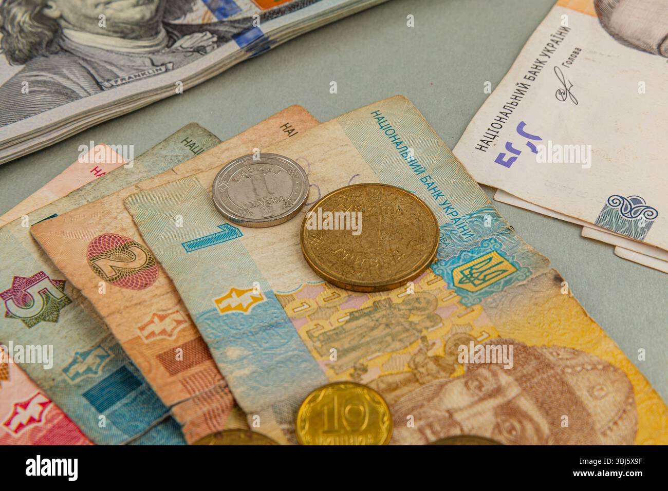 Different denominations of Ukrainian currency are arranged on a table ...