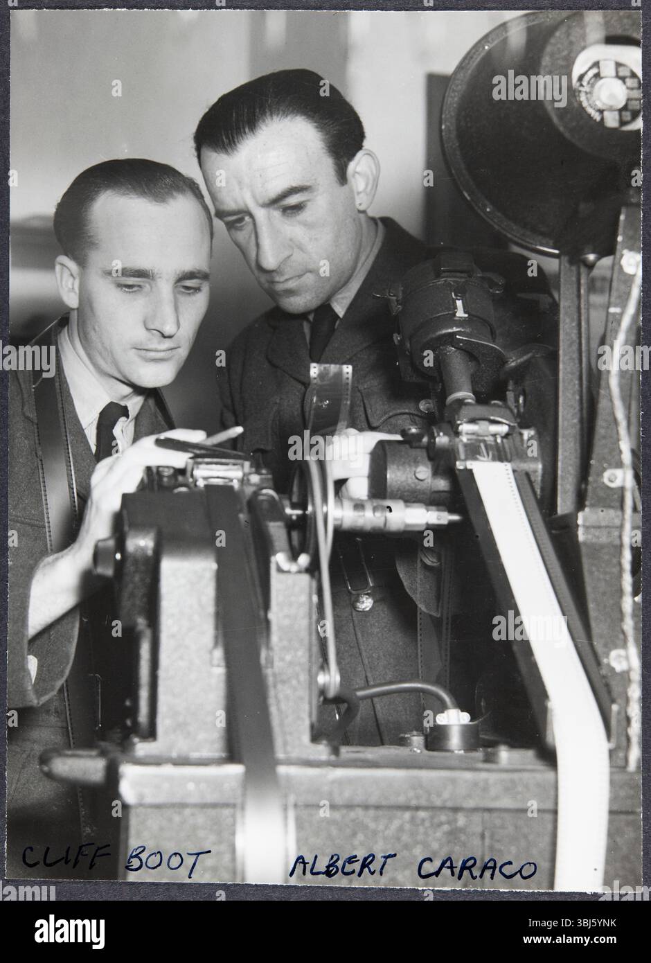 RAF aviators Cliff Boot and Albert Caraco at work in the RAF Film Production Unit cutting room ...