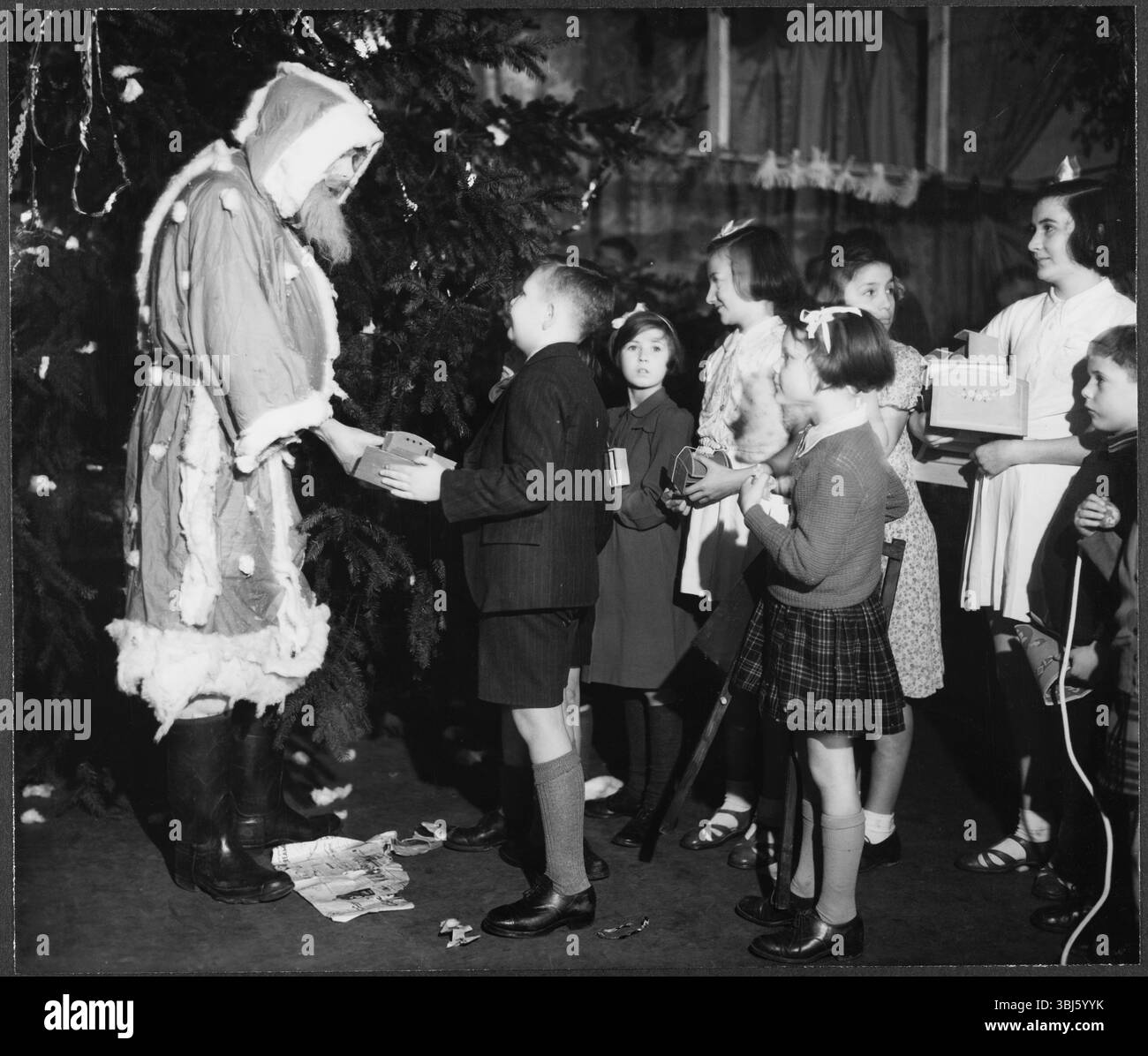 Children lining up to receive gifts from Father Christmas, at the RAF ...