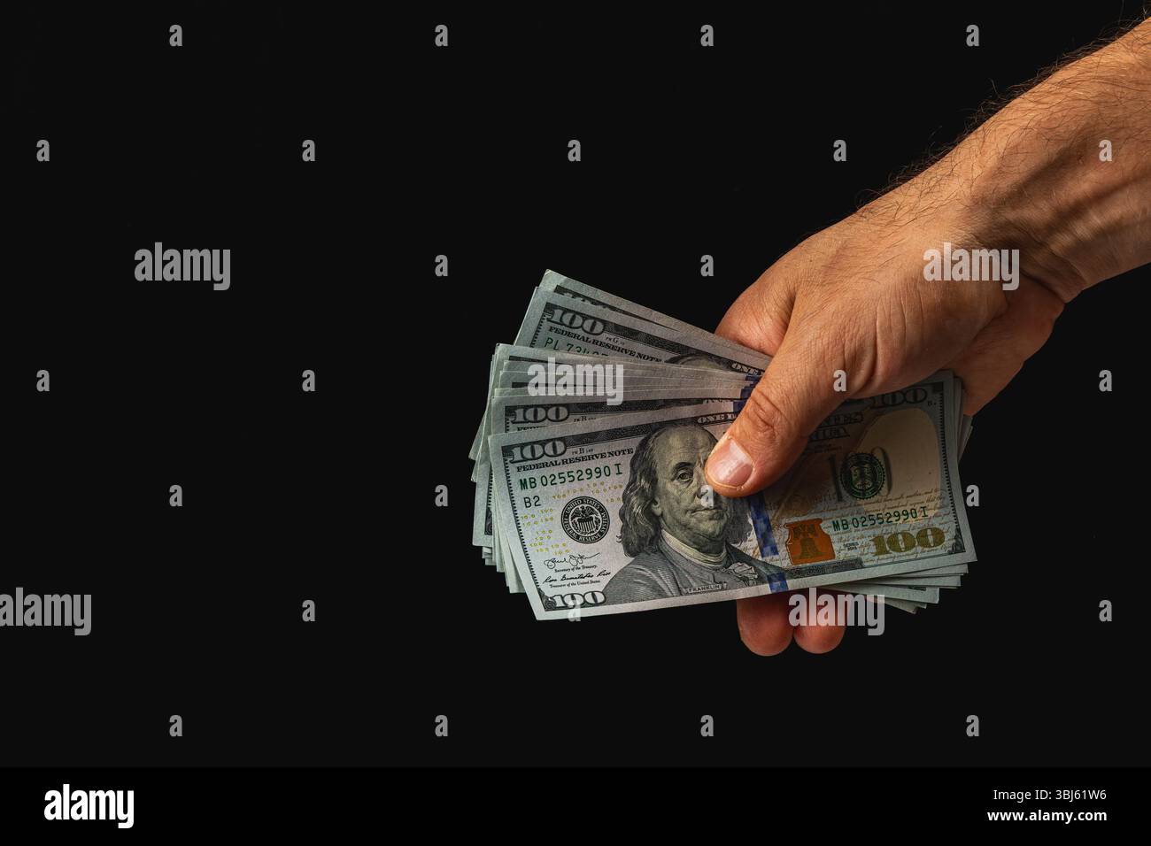 Hand holding multiple dollar bills hi-res stock photography and images ...
