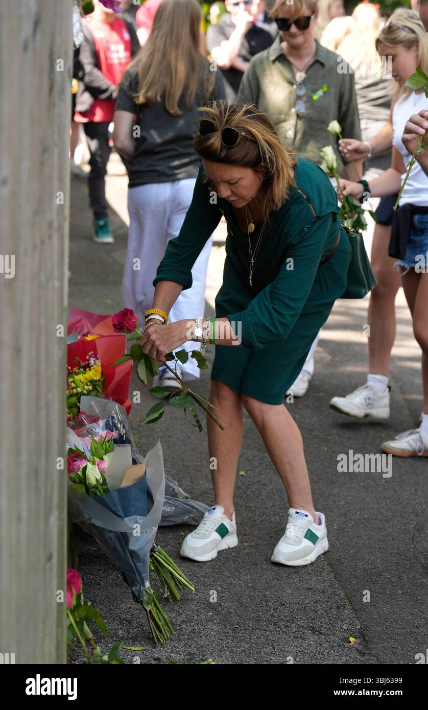 Emma Webber, the mother of Barnaby Webber lays flowers on Magdala Road ...