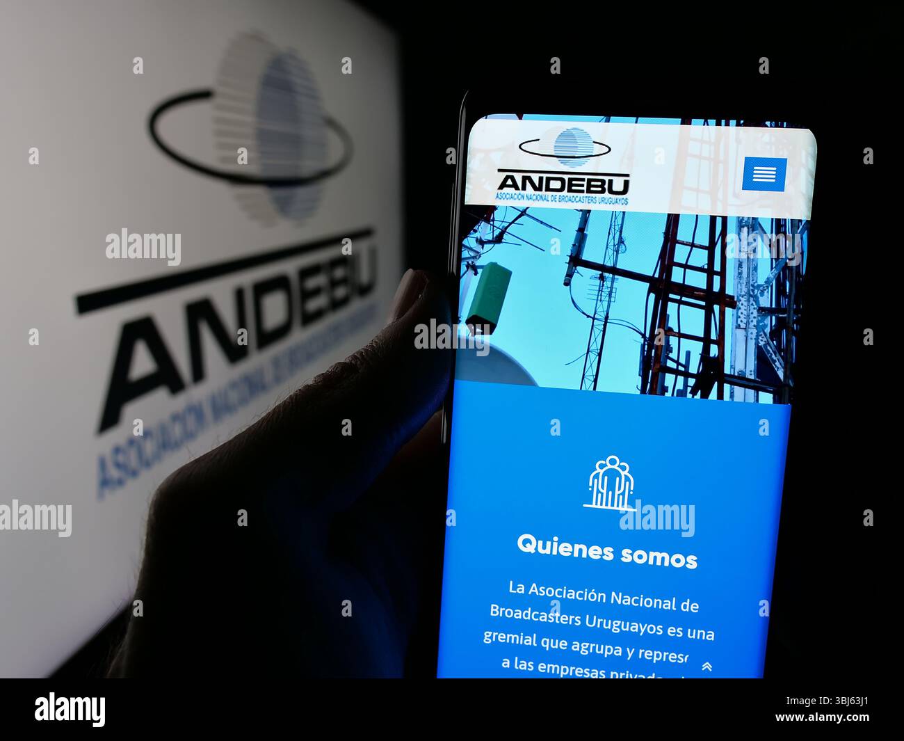 Stuttgart, Germany - 04-03-2025: Person holding web page with logo of ...