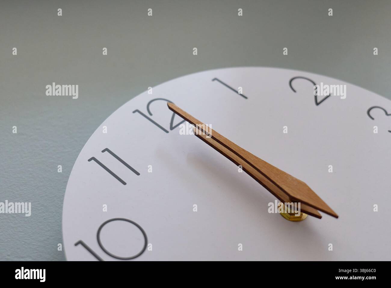 modern wall clock features wooden hands and clear numbers Stock Photo ...